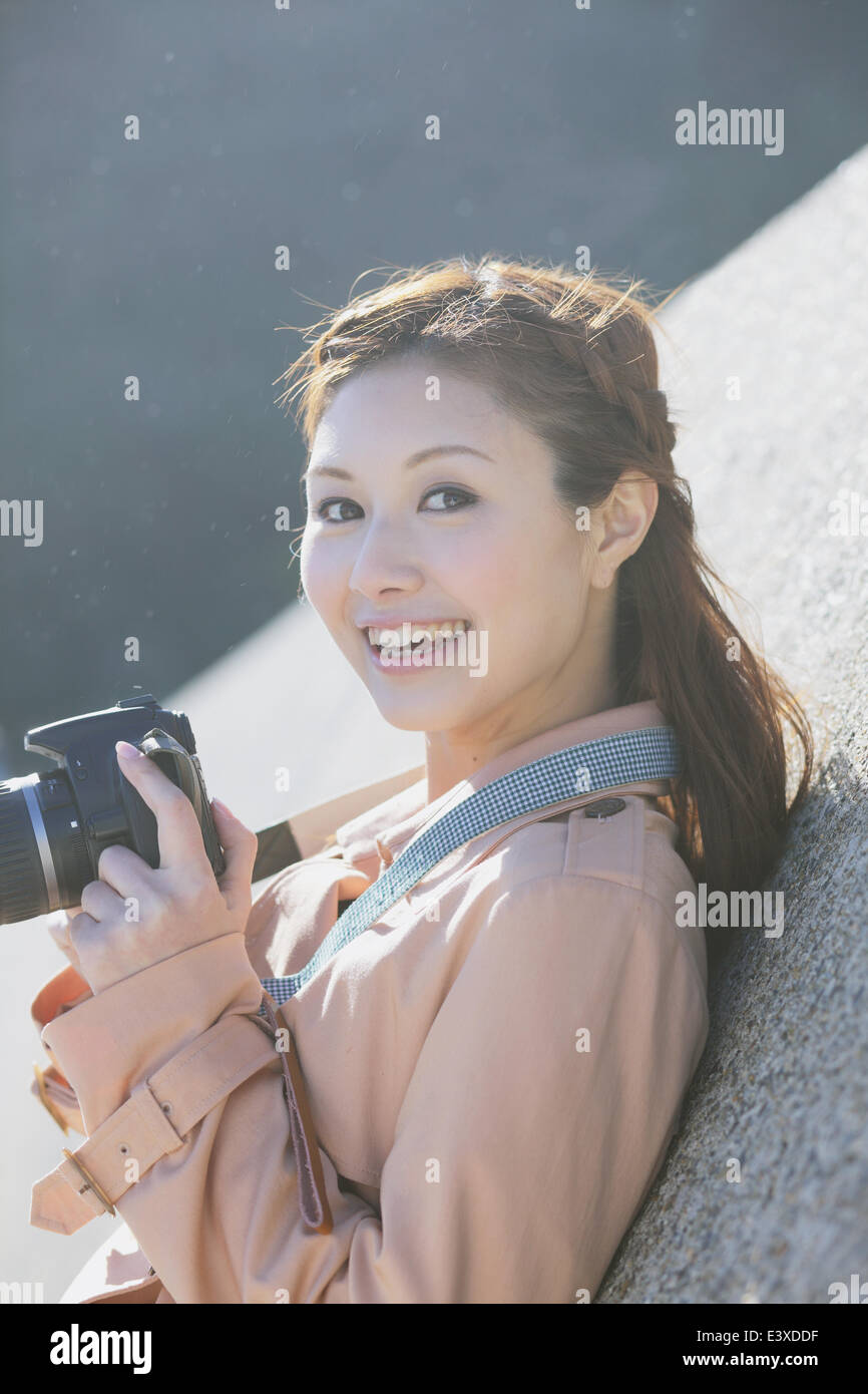 Portrait of Japanese woman with camera smiling Stock Photo - Alamy