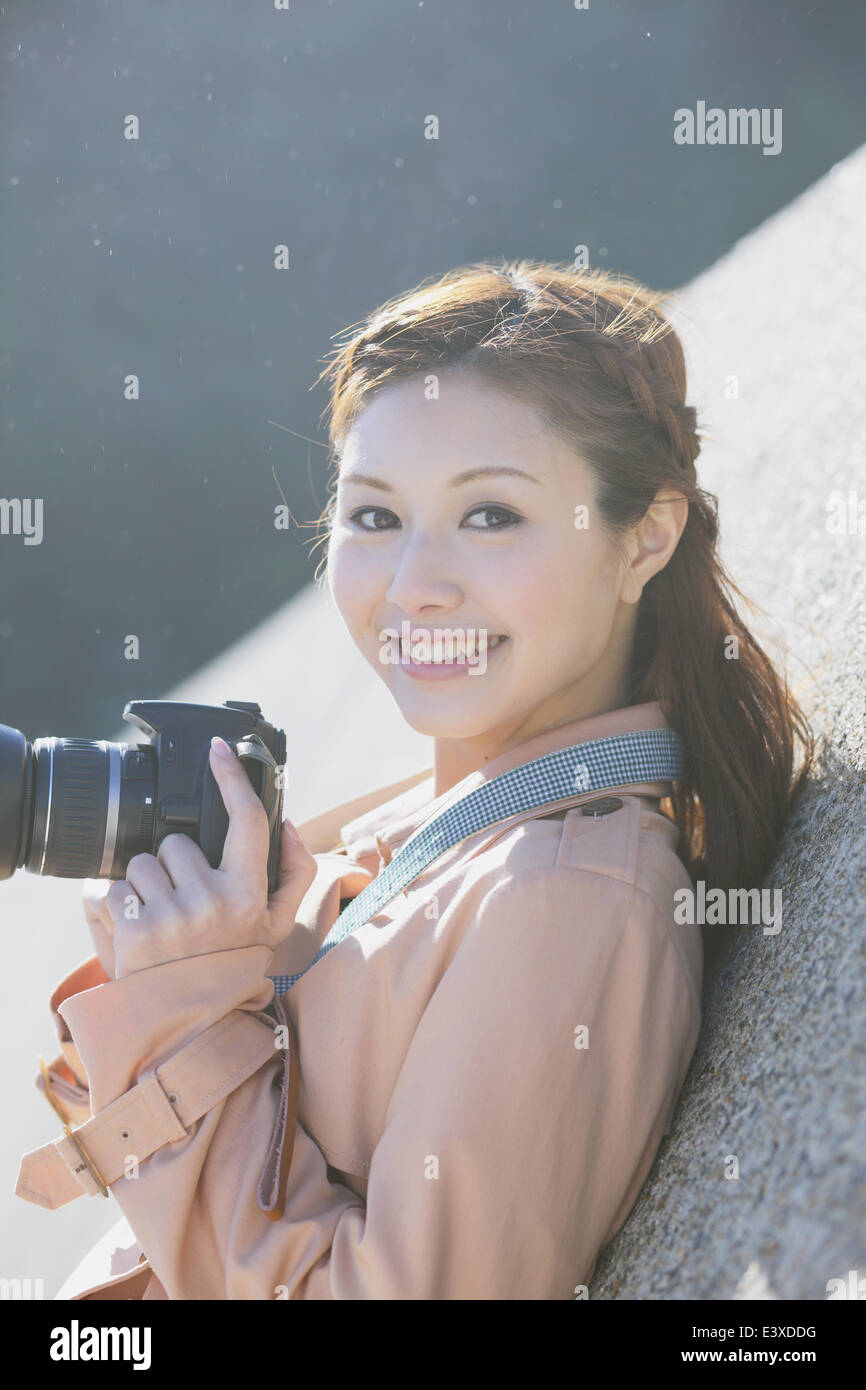 Portrait of Japanese woman with camera smiling Stock Photo - Alamy