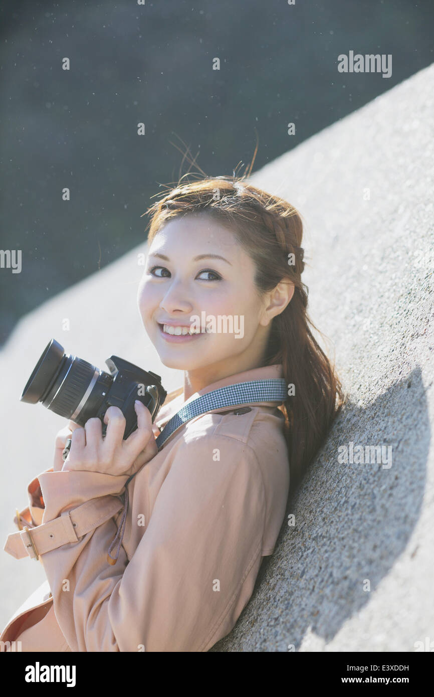 Portrait of Japanese woman with camera smiling Stock Photo - Alamy
