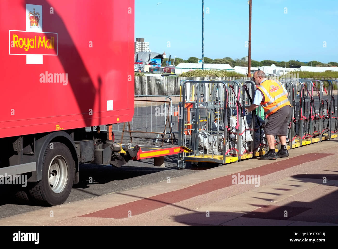 royal mail workers load mail onto trolleys after it has arrived in ...