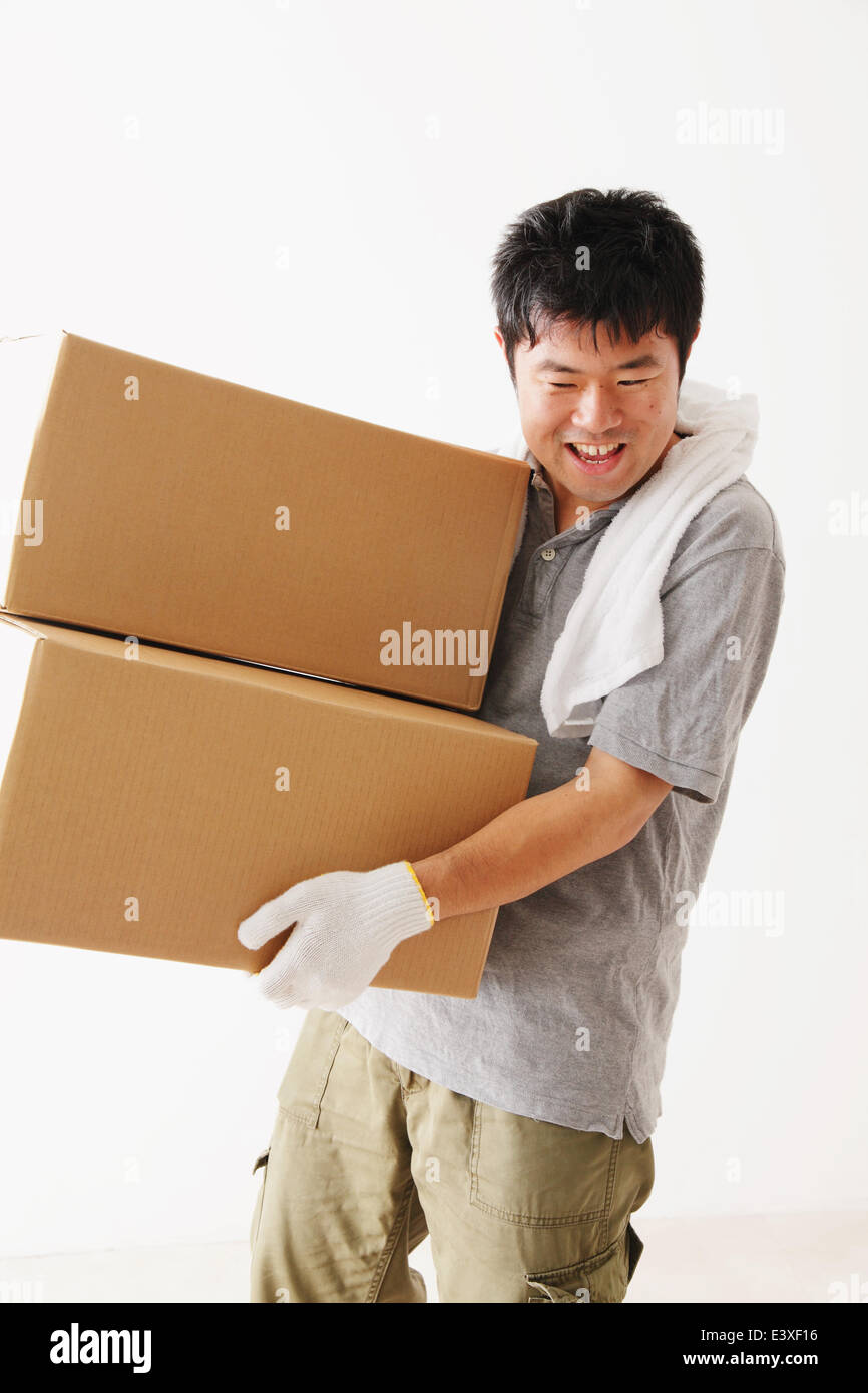 Man lifting heavy boxes hi-res stock photography and images - Alamy