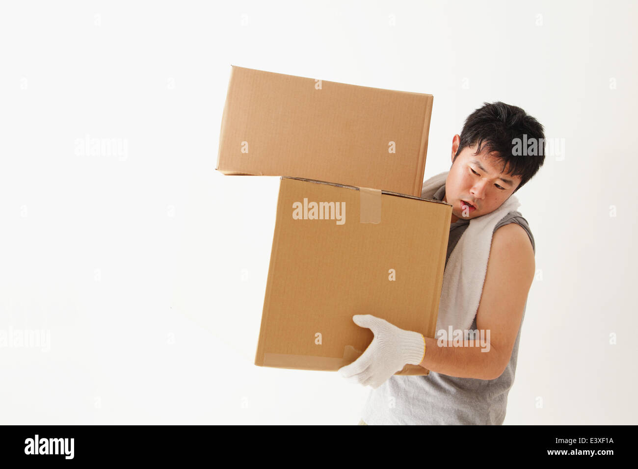 Japanese man with heavy boxes Stock Photo - Alamy