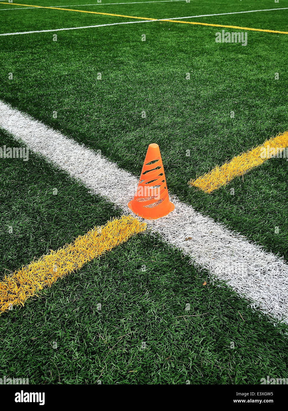 Orange cone on field boundary Stock Photo - Alamy