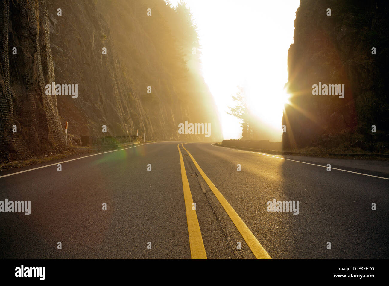 Rural road cutting through mountains Stock Photo - Alamy