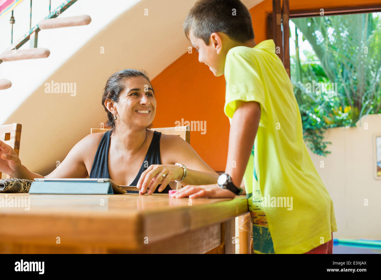 Happy family talking table hi-res stock photography and images - Alamy