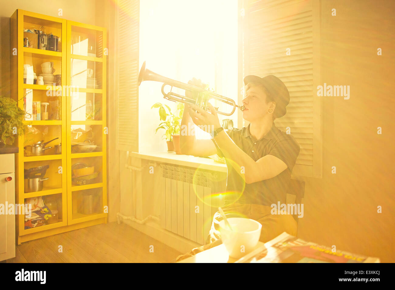 Caucasian man playing trumpet in kitchen Stock Photo - Alamy