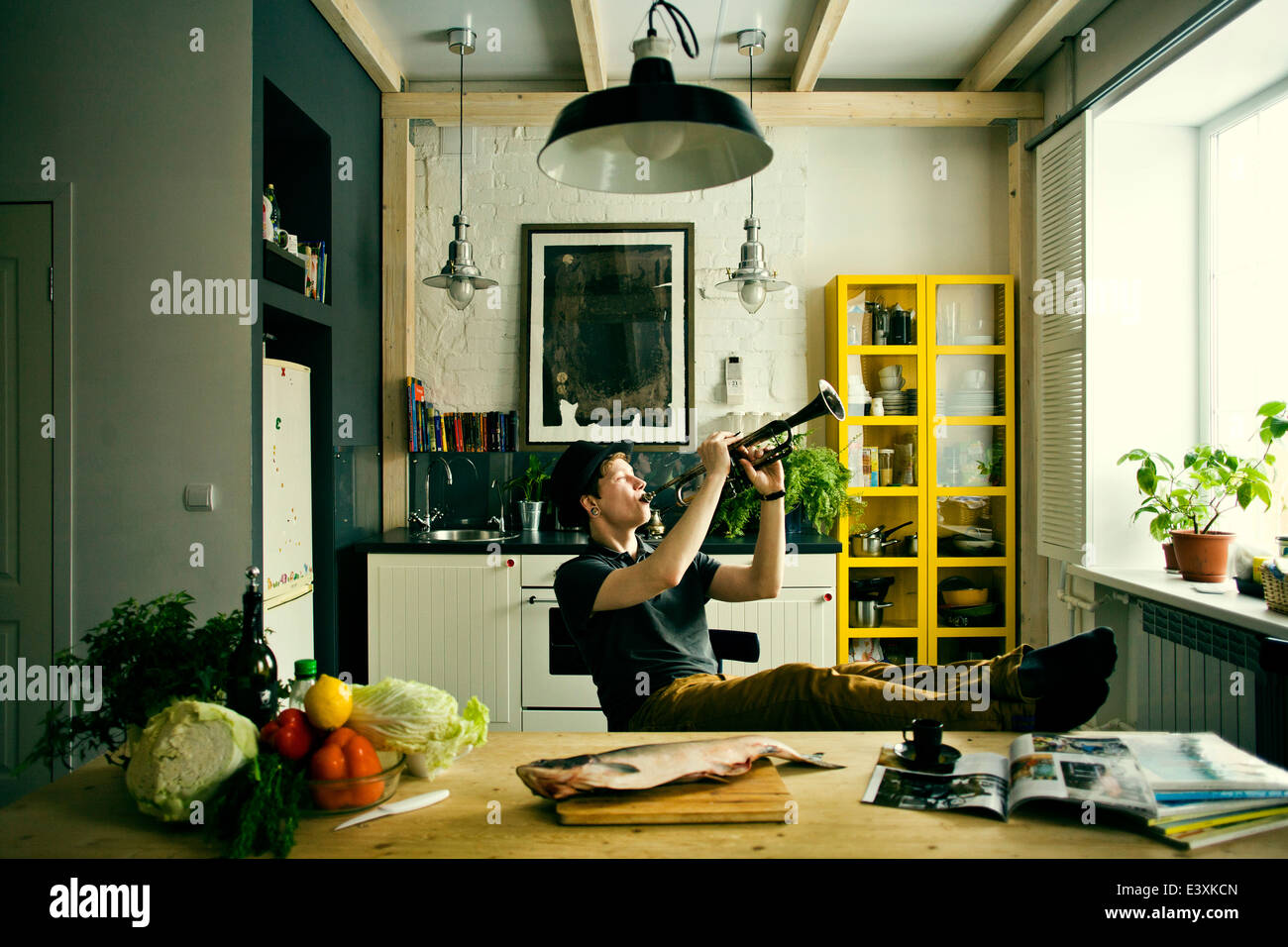Caucasian man playing trumpet in kitchen Stock Photo - Alamy