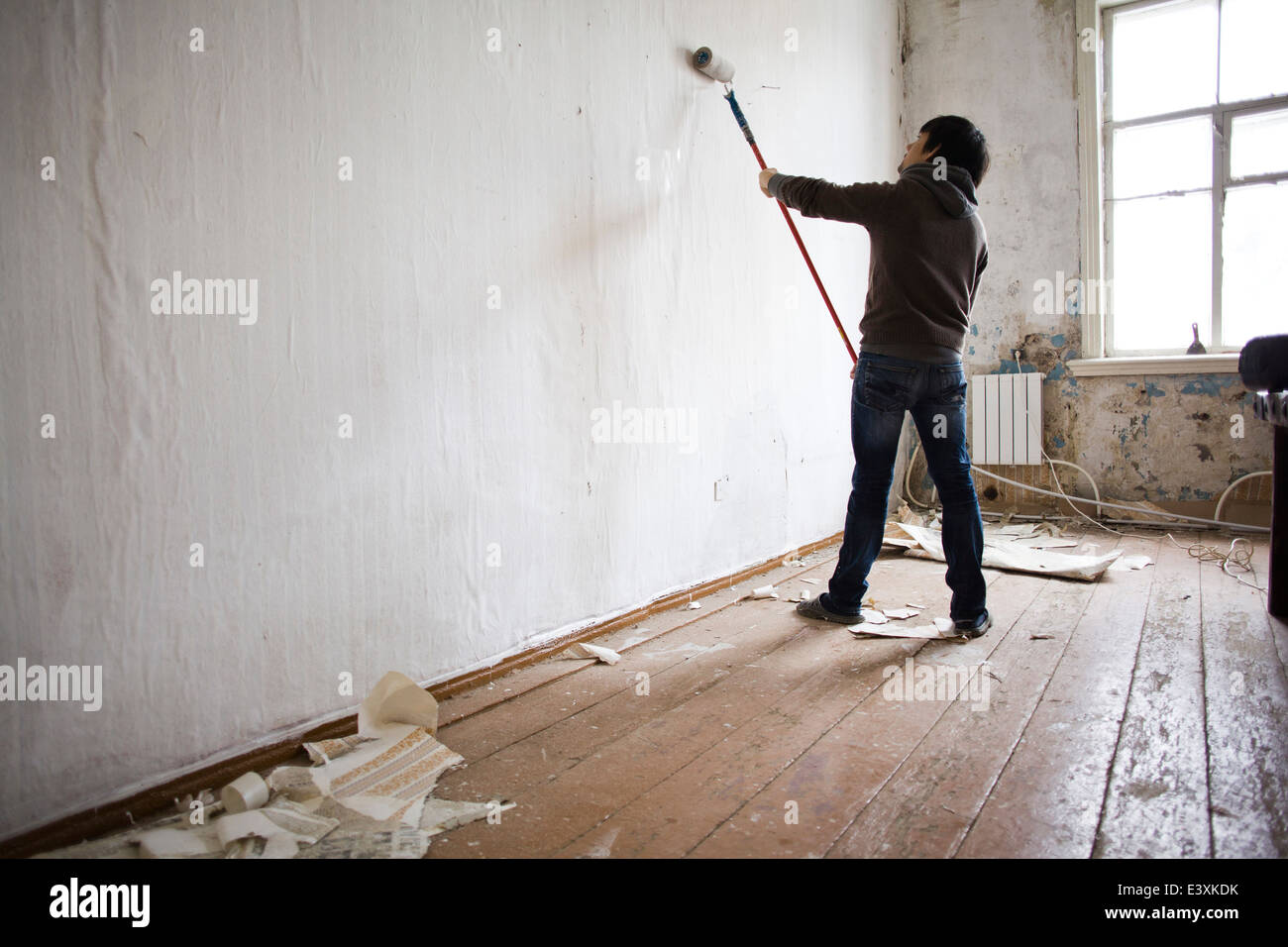 Mari man painting walls in new home Stock Photo - Alamy