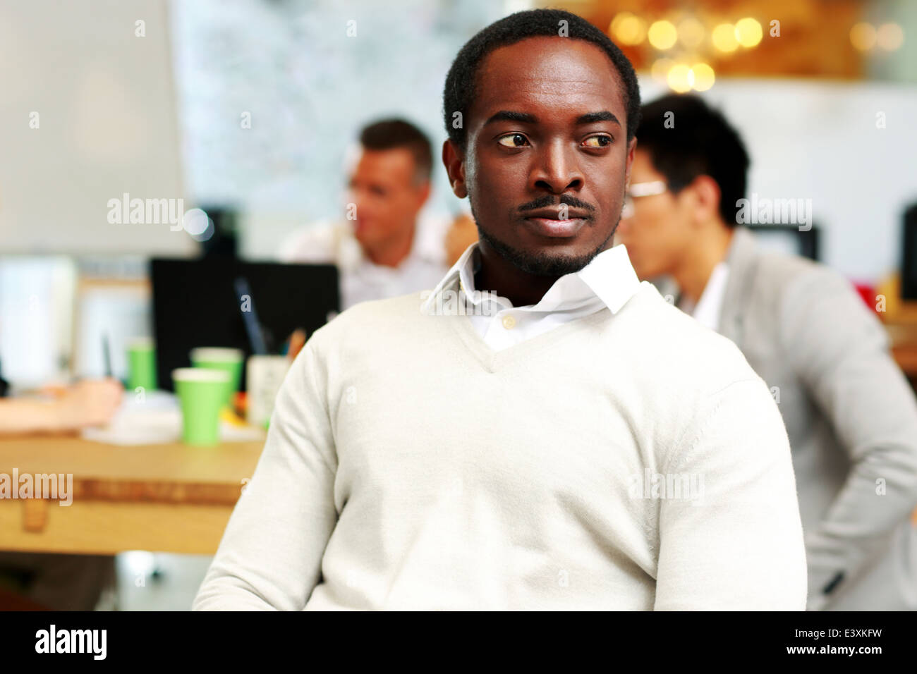 Portrait of a pensive african man looking away in office Stock Photo ...