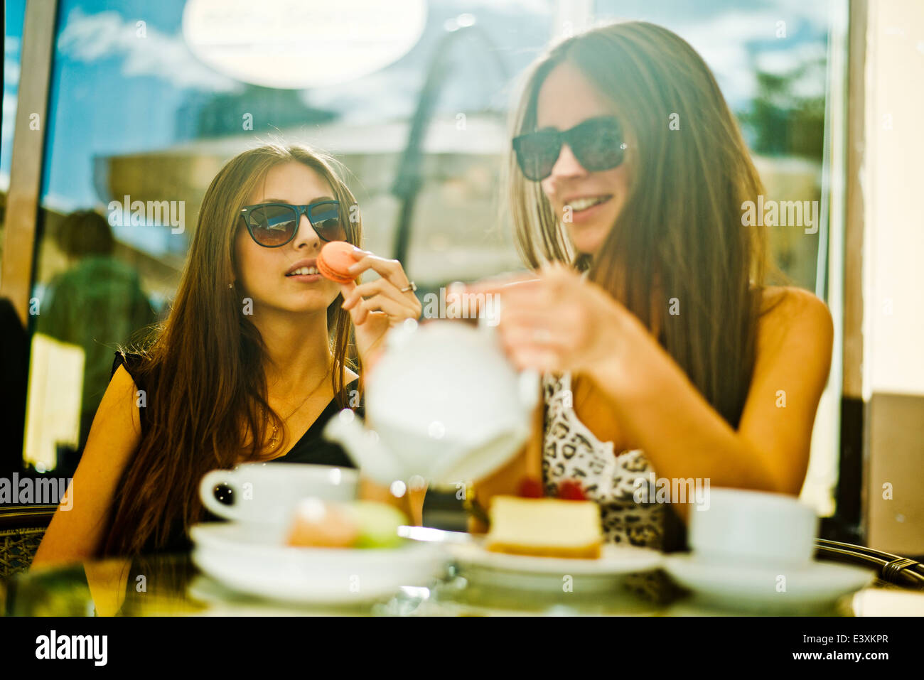Women having coffee together at sidewalk cafe Stock Photo - Alamy