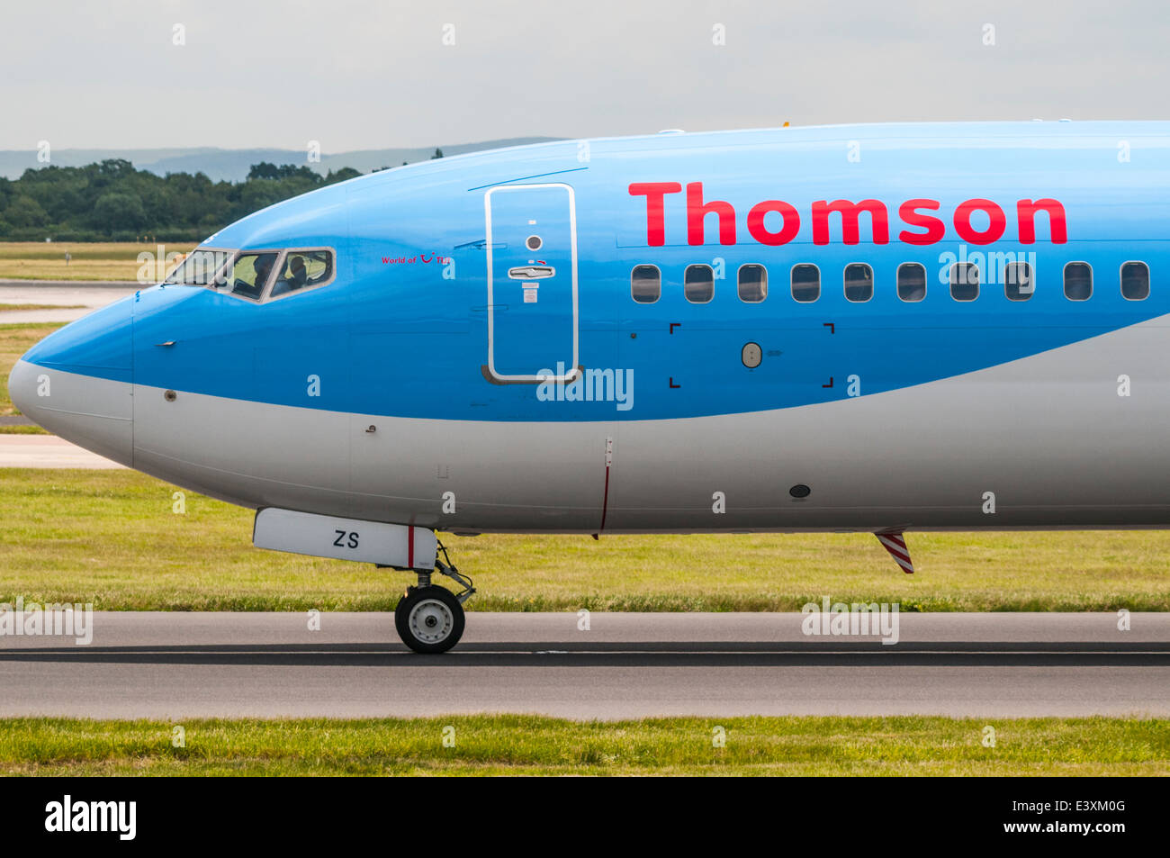 Side view of the front of a Thomson Boeing 737 plane as it passes on a ...