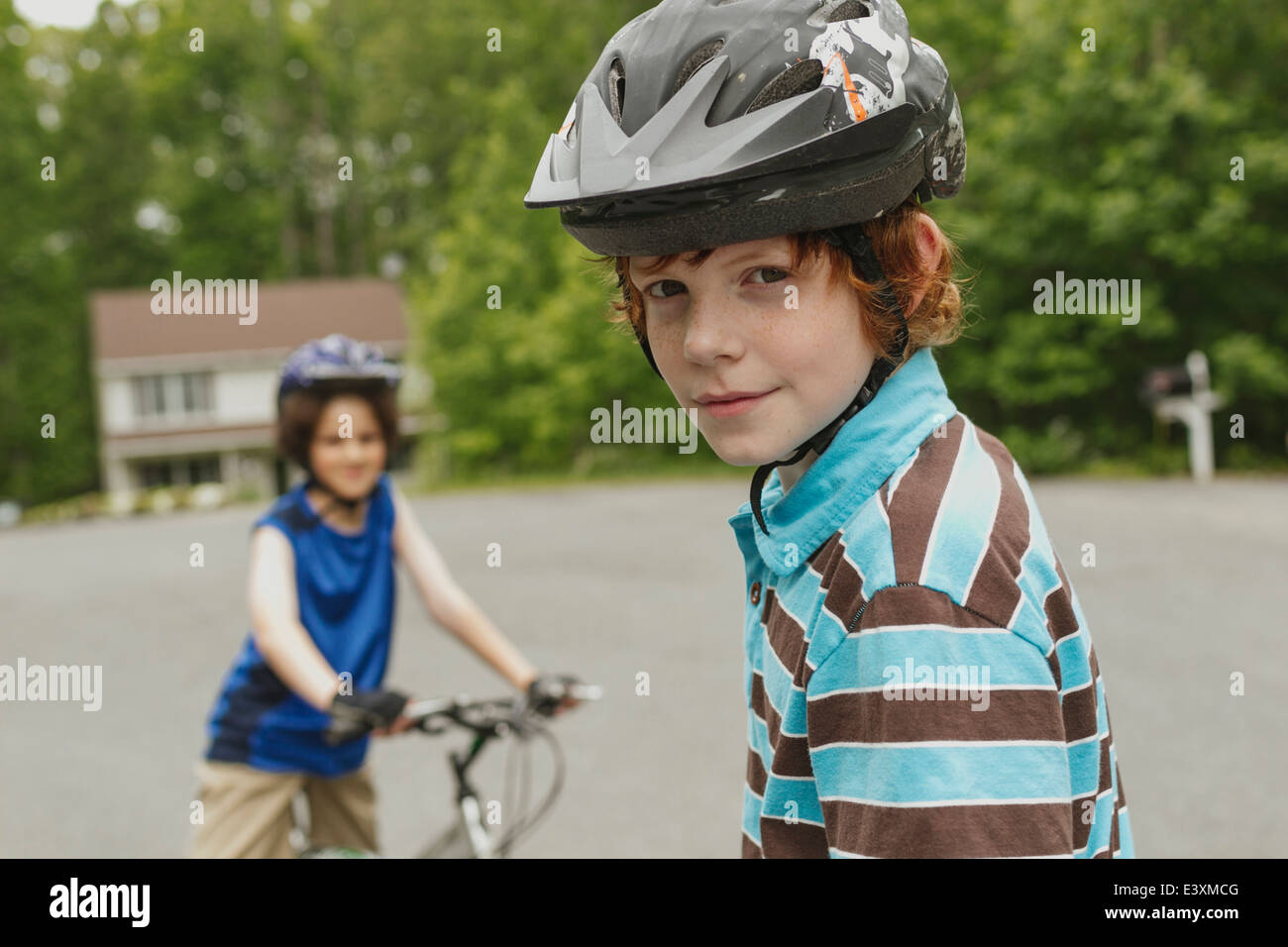 Boys riding bicycles together outdoors Stock Photo - Alamy