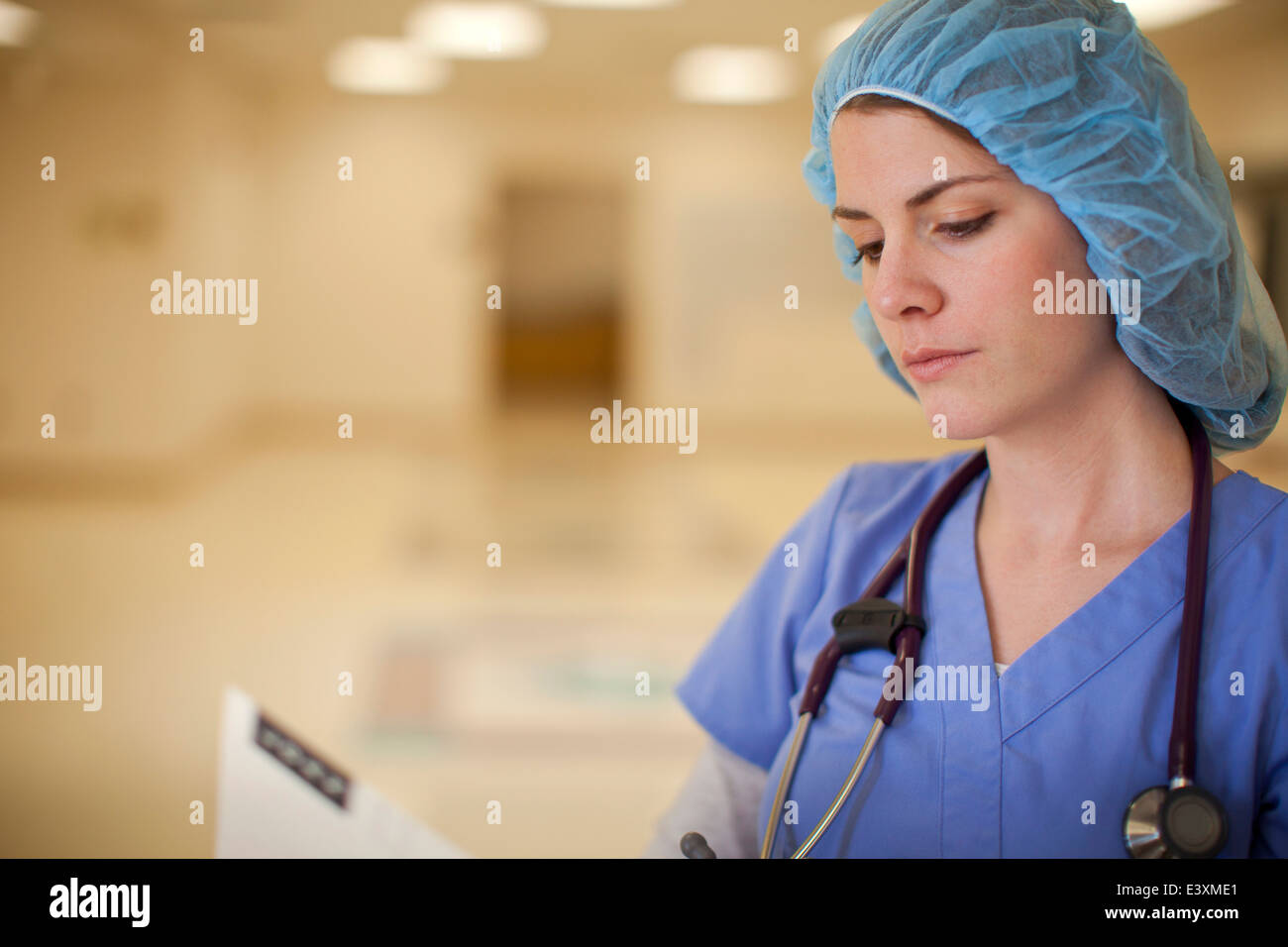 Caucasian nurse reading medical chart in hospital Stock Photo - Alamy