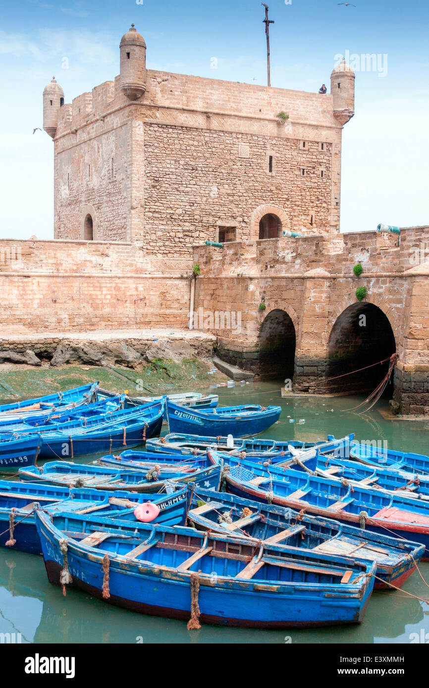 Traditional, blue painted fishing boats in the harbour below the Sqala ...