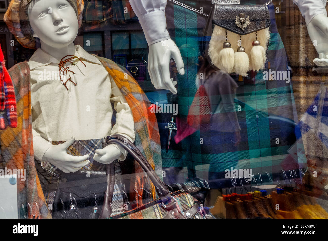 Shop window display show traditional tartan outfits. Street reflected ...