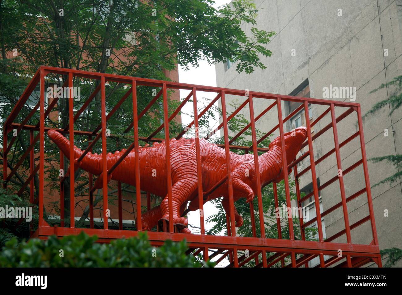 The figure of a red dragon trapped in a red cage is on display in the ...