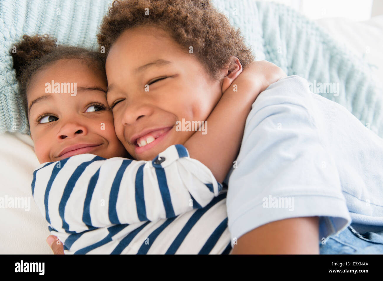 Black children hugging on sofa Stock Photo - Alamy