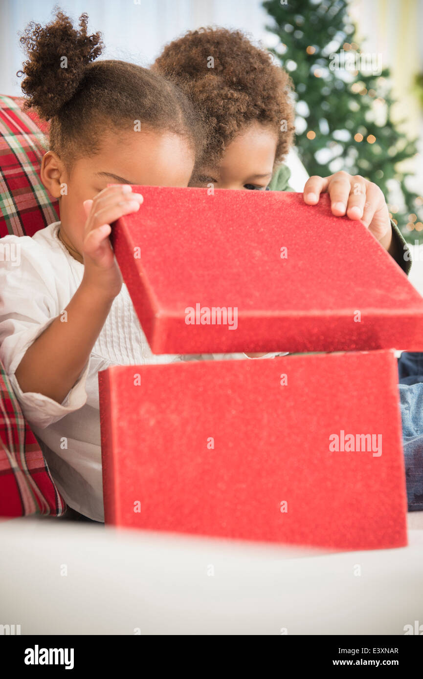Child opening gift hi-res stock photography and images - Alamy