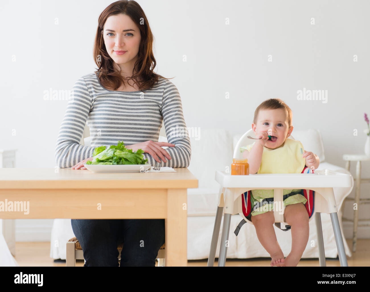 Mother and baby eating together Stock Photo - Alamy