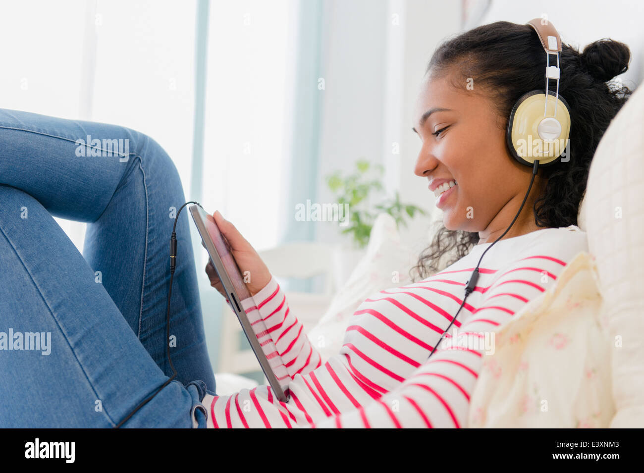 Happy woman watching listening media hi-res stock photography and ...