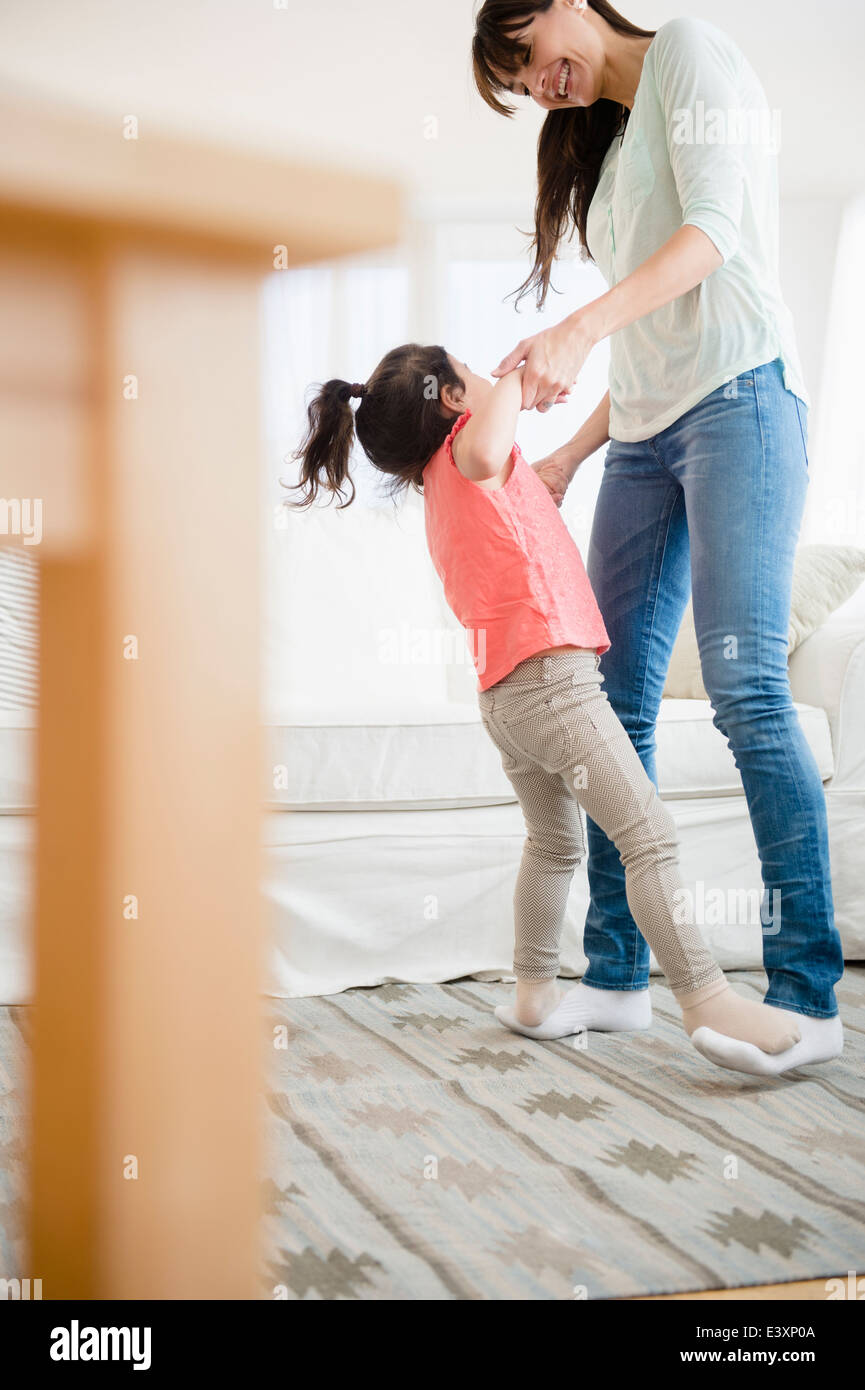 Hispanic mother and daughter dancing together Stock Photo - Alamy
