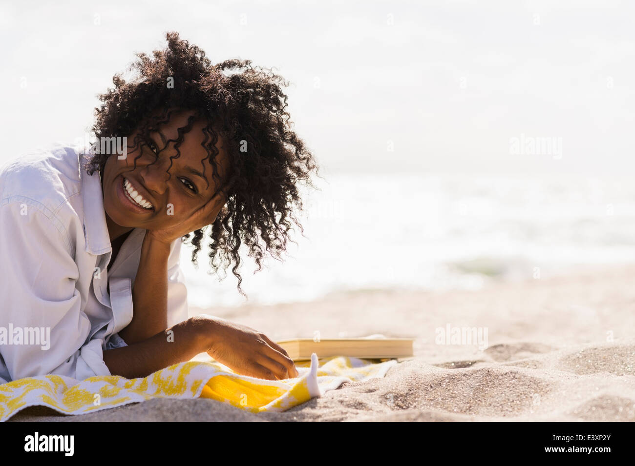 African American woman relaxing on beach Stock Photo - Alamy