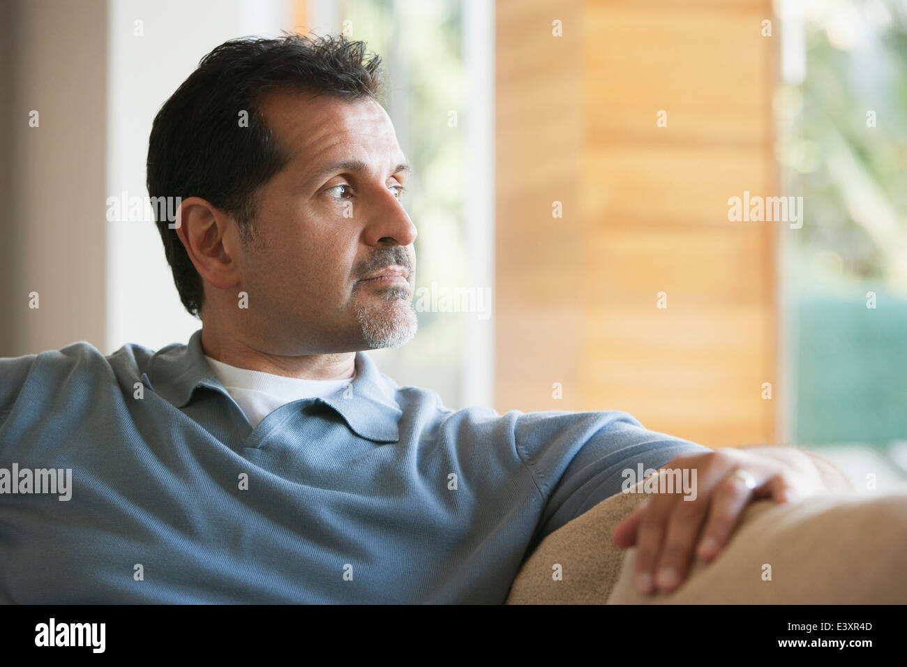 Hispanic man relaxing on sofa Stock Photo - Alamy