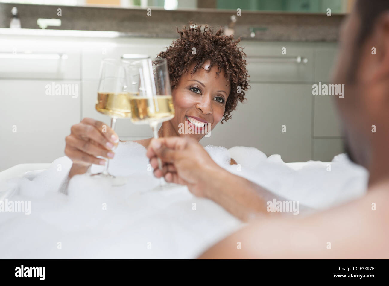 African American couple drinking champagne in bath Stock Photo - Alamy