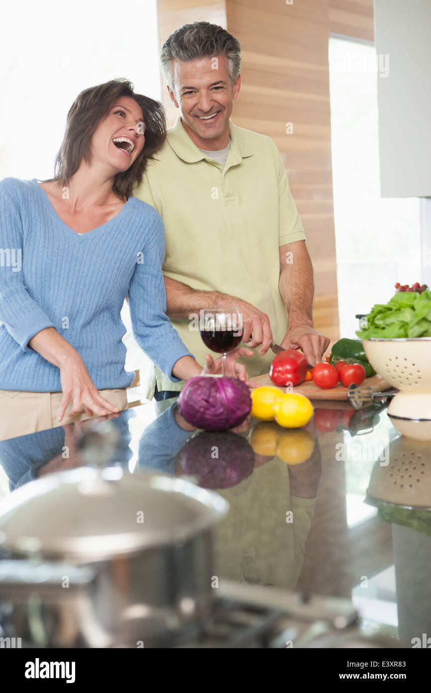 Hispanic couple cooking in kitchen Stock Photo - Alamy
