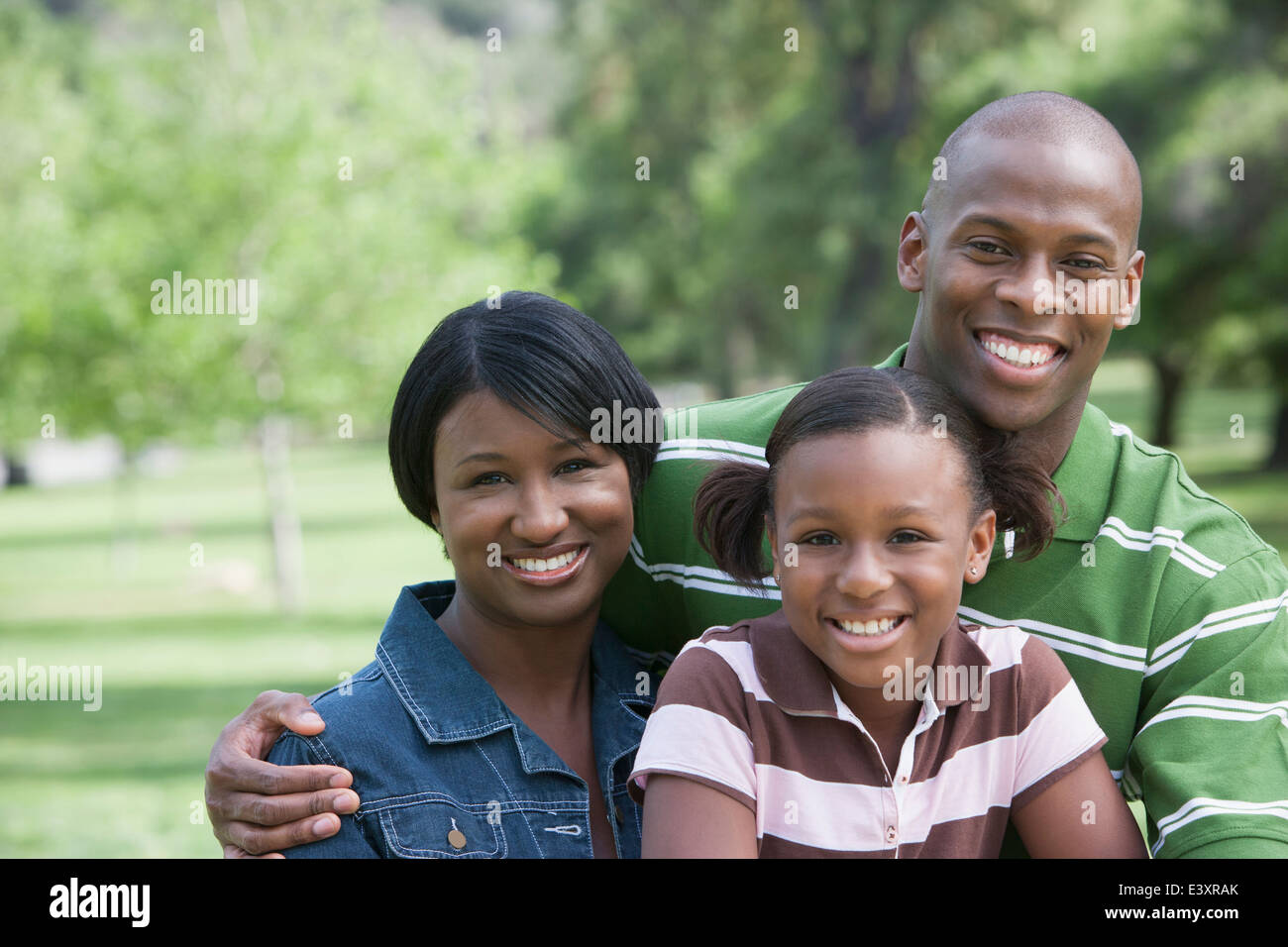 Family smiling together in park Stock Photo - Alamy
