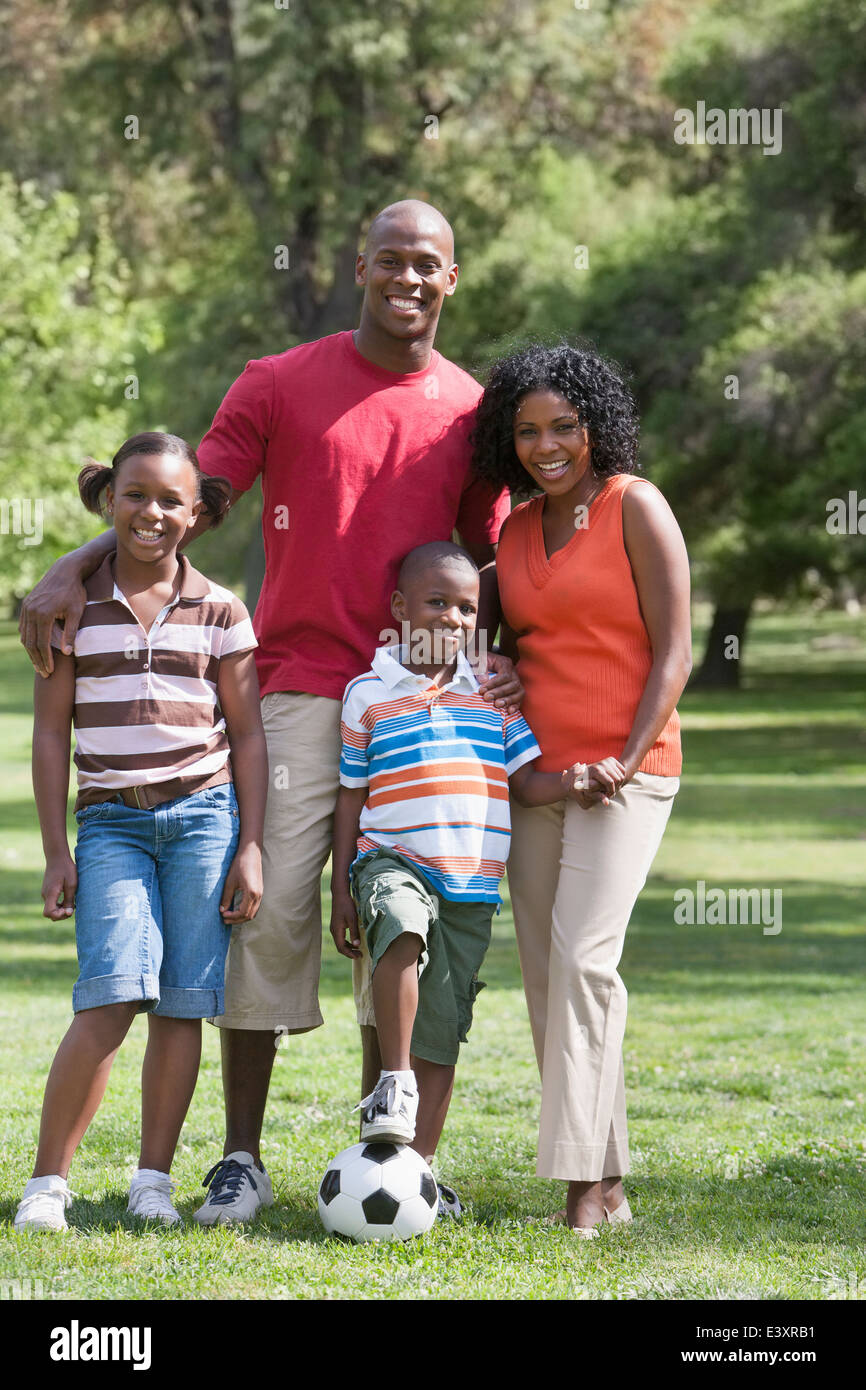 Family playing soccer in park Stock Photo - Alamy