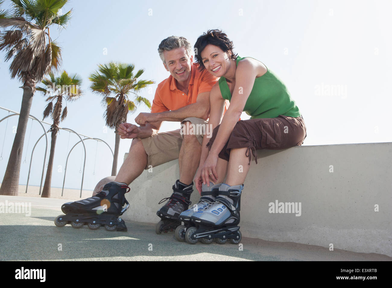 Caucasian couple rollerblading by beach Stock Photo - Alamy