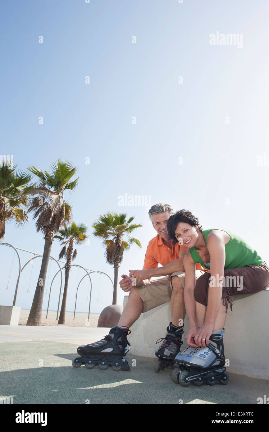 Caucasian couple rollerblading by beach Stock Photo - Alamy