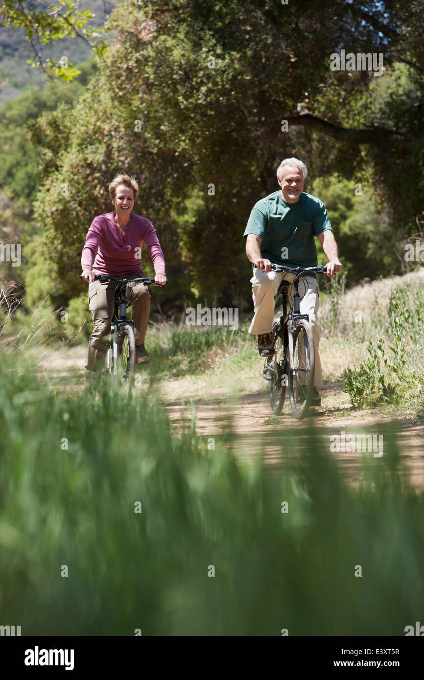 Senior Caucasian couple riding bicycles on rural path Stock Photo - Alamy