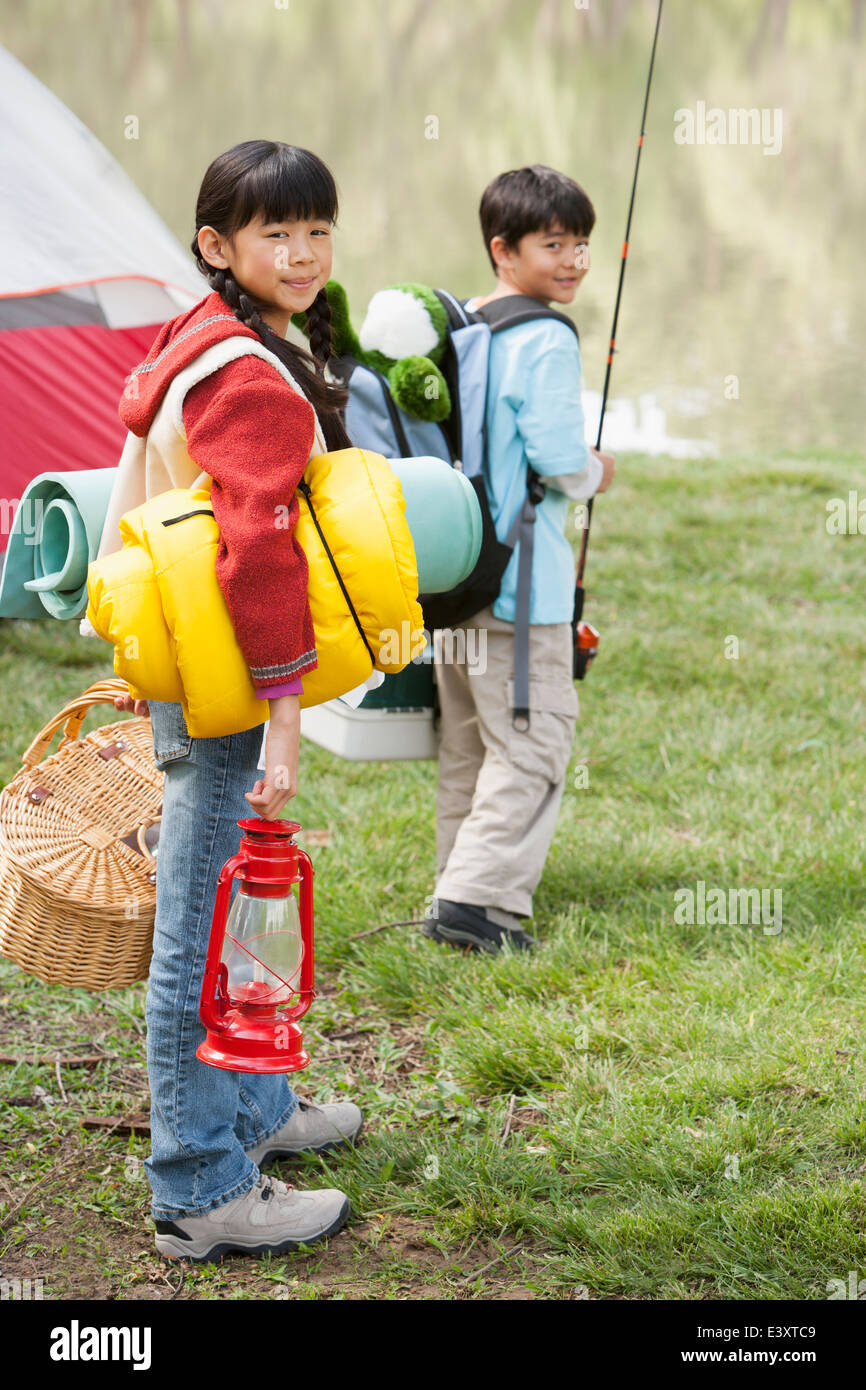 Children carrying camping gear outdoors Stock Photo - Alamy