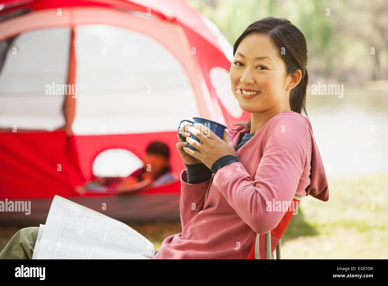 Woman drinking coffee at campsite Stock Photo - Alamy