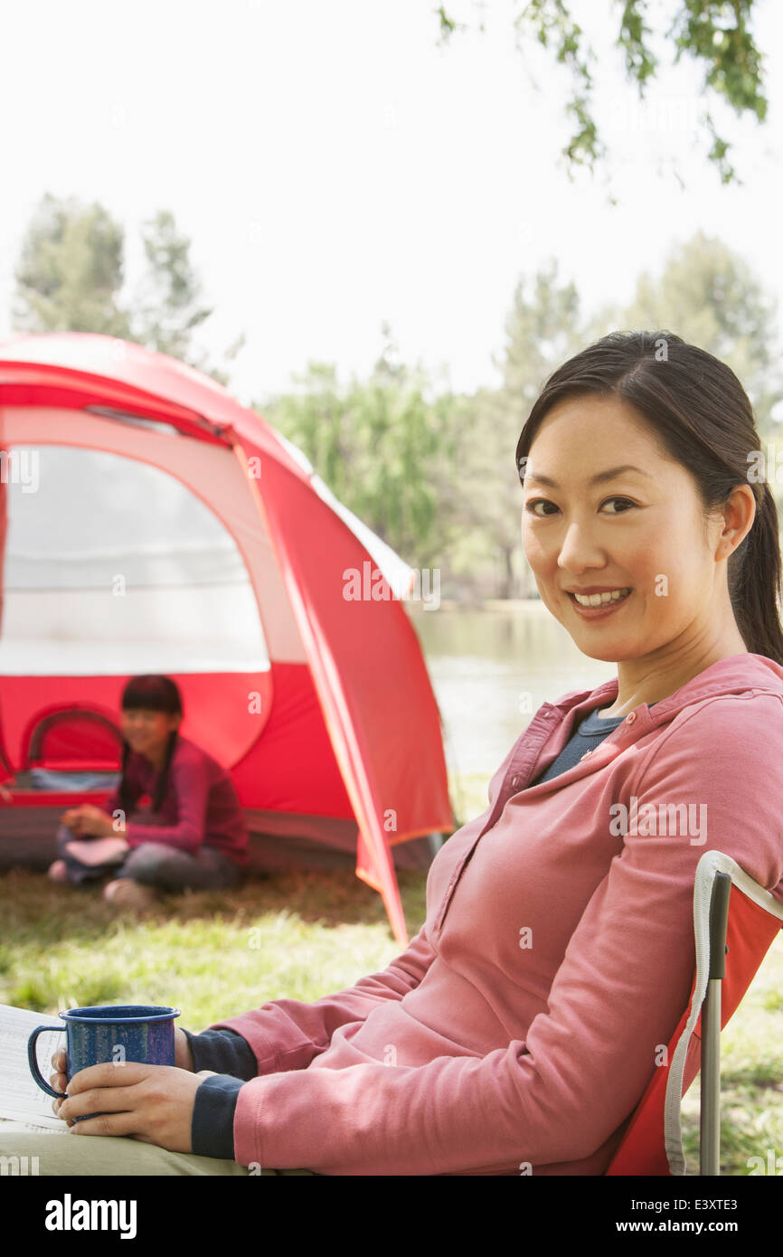 Woman drinking coffee at campsite Stock Photo - Alamy