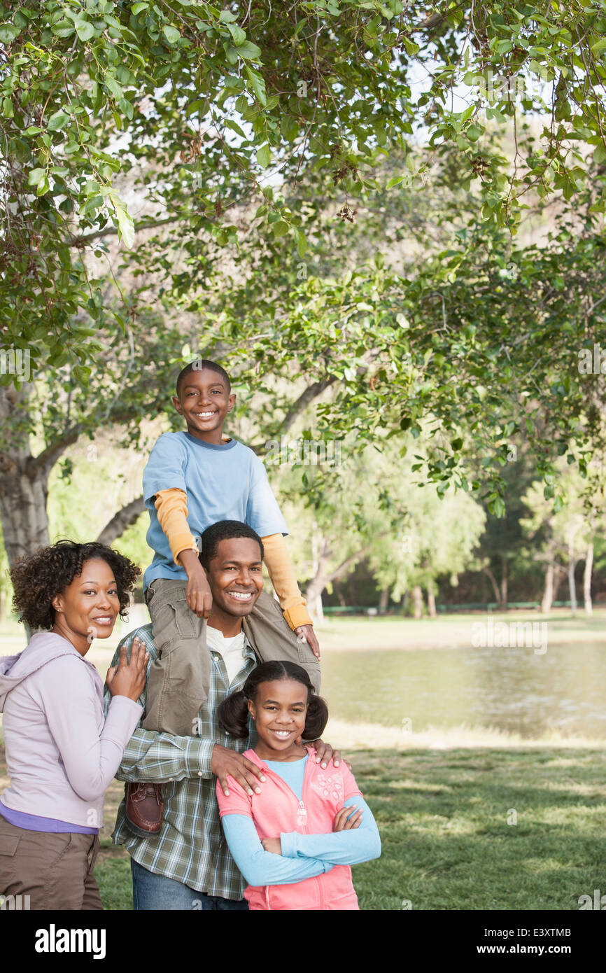 Family smiling together in park Stock Photo - Alamy