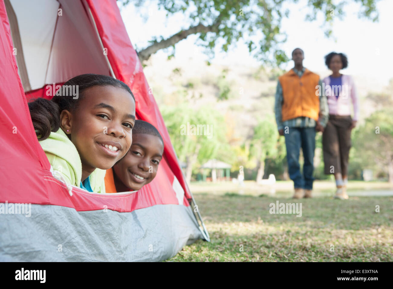 Children peeking out of tent at campsite Stock Photo - Alamy
