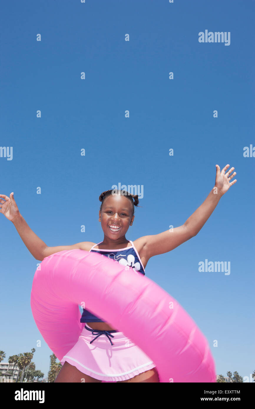 African American girl playing with inner tube Stock Photo - Alamy