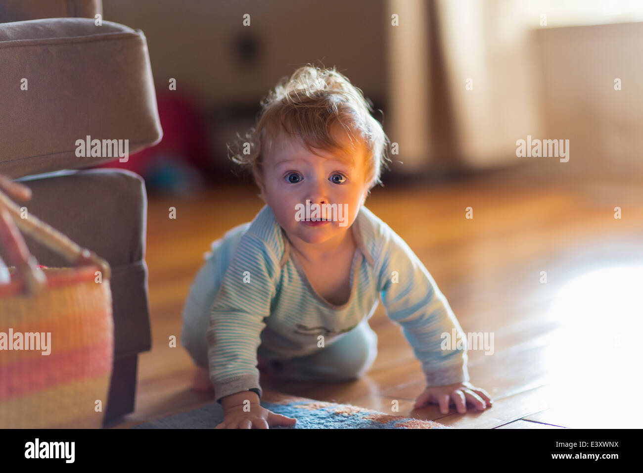 Caucasian baby crawling on floor Stock Photo - Alamy