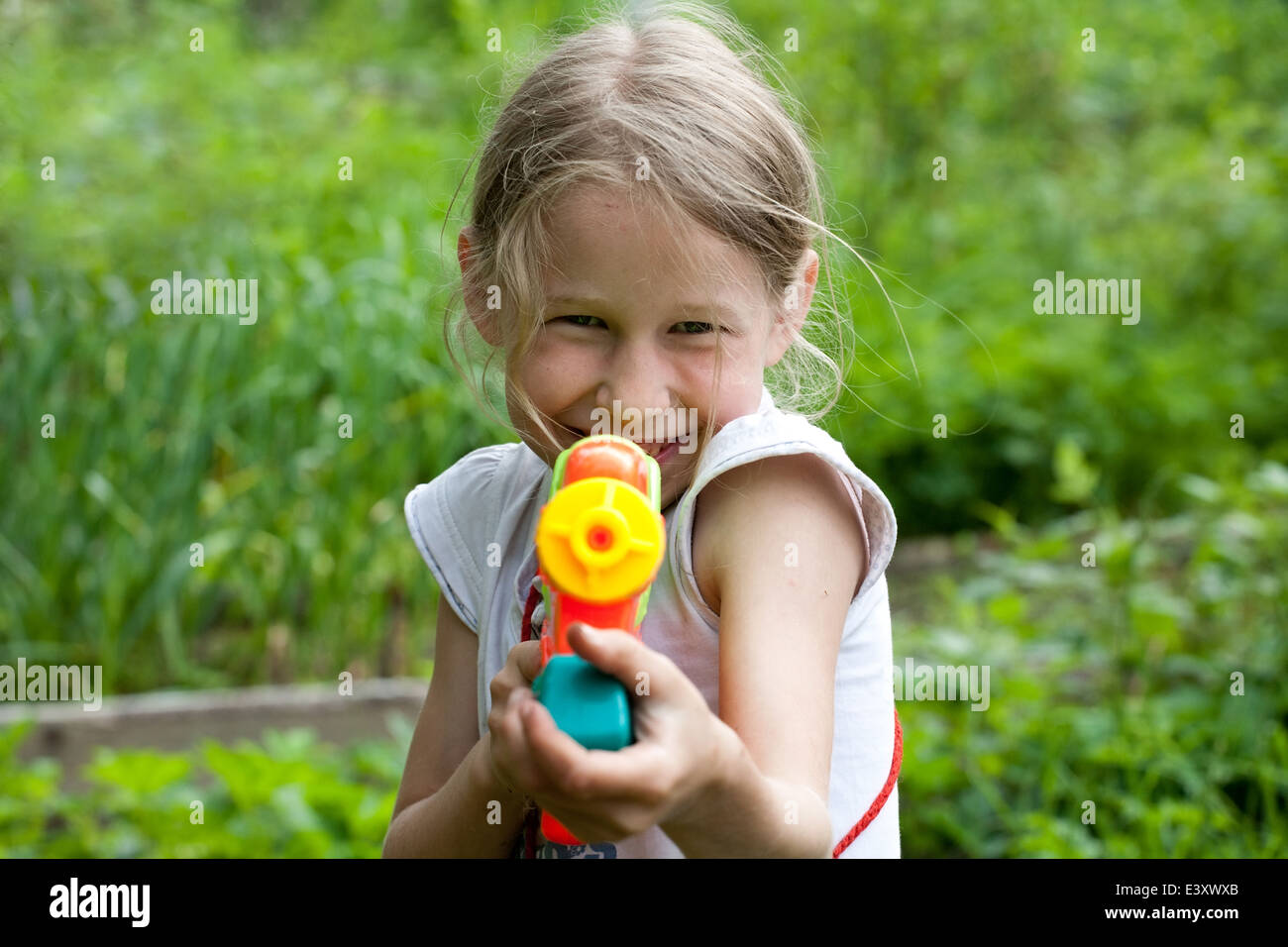 small girl shooting from funny toy water gun Stock Photo - Alamy
