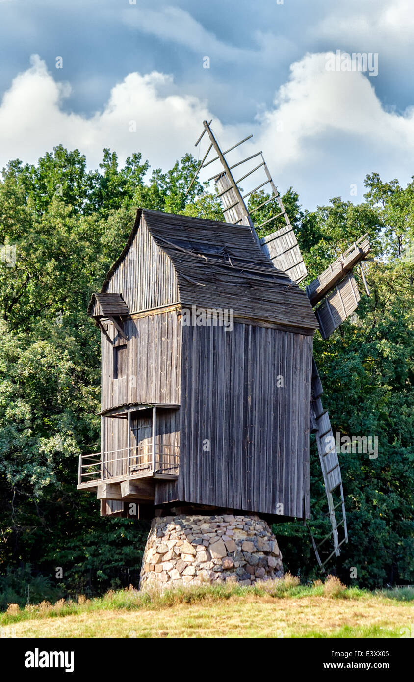 Old wooden traditional ukrainian windmill over blue sky with clouds ...