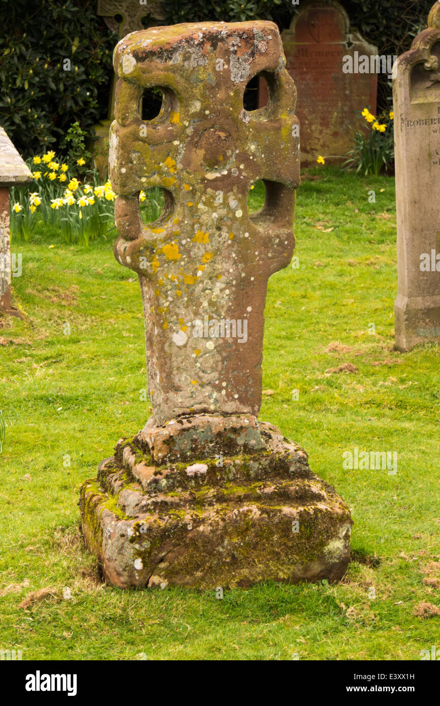 An ancient stone cross in the grave yard of the Church of St. Michael ...