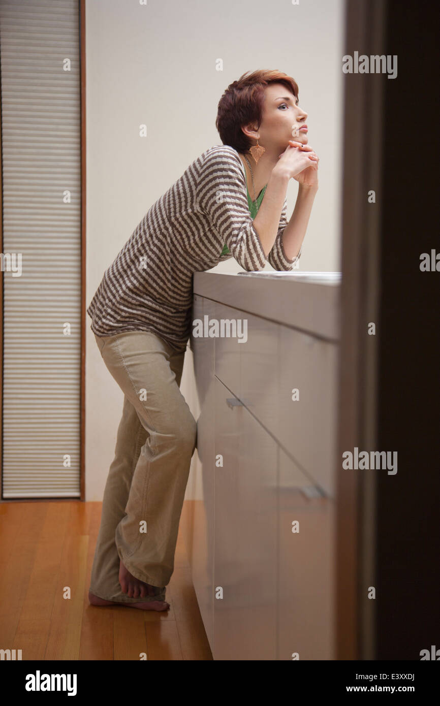Leaning on counter hi-res stock photography and images - Alamy