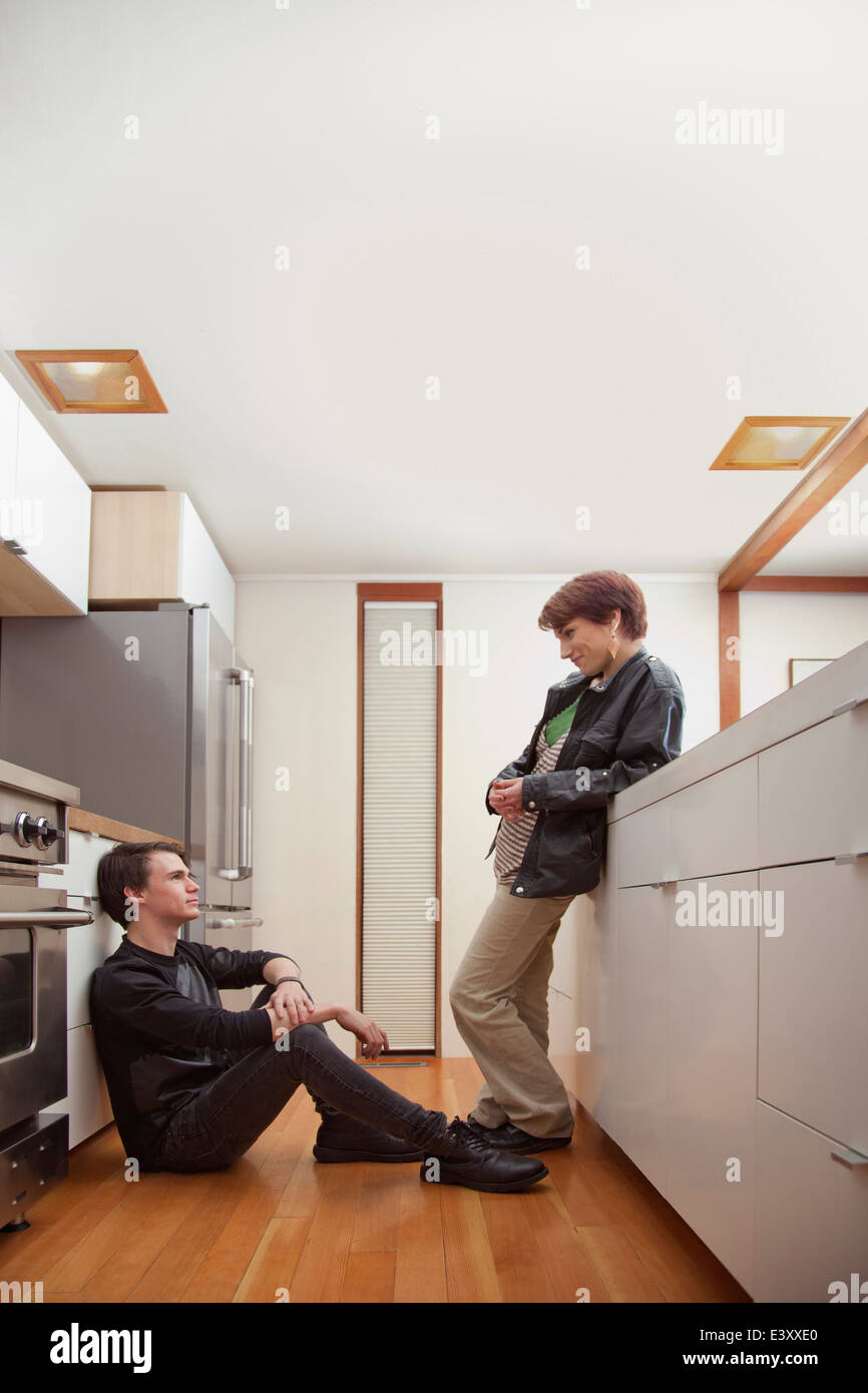 Couple talking in kitchen Stock Photo - Alamy