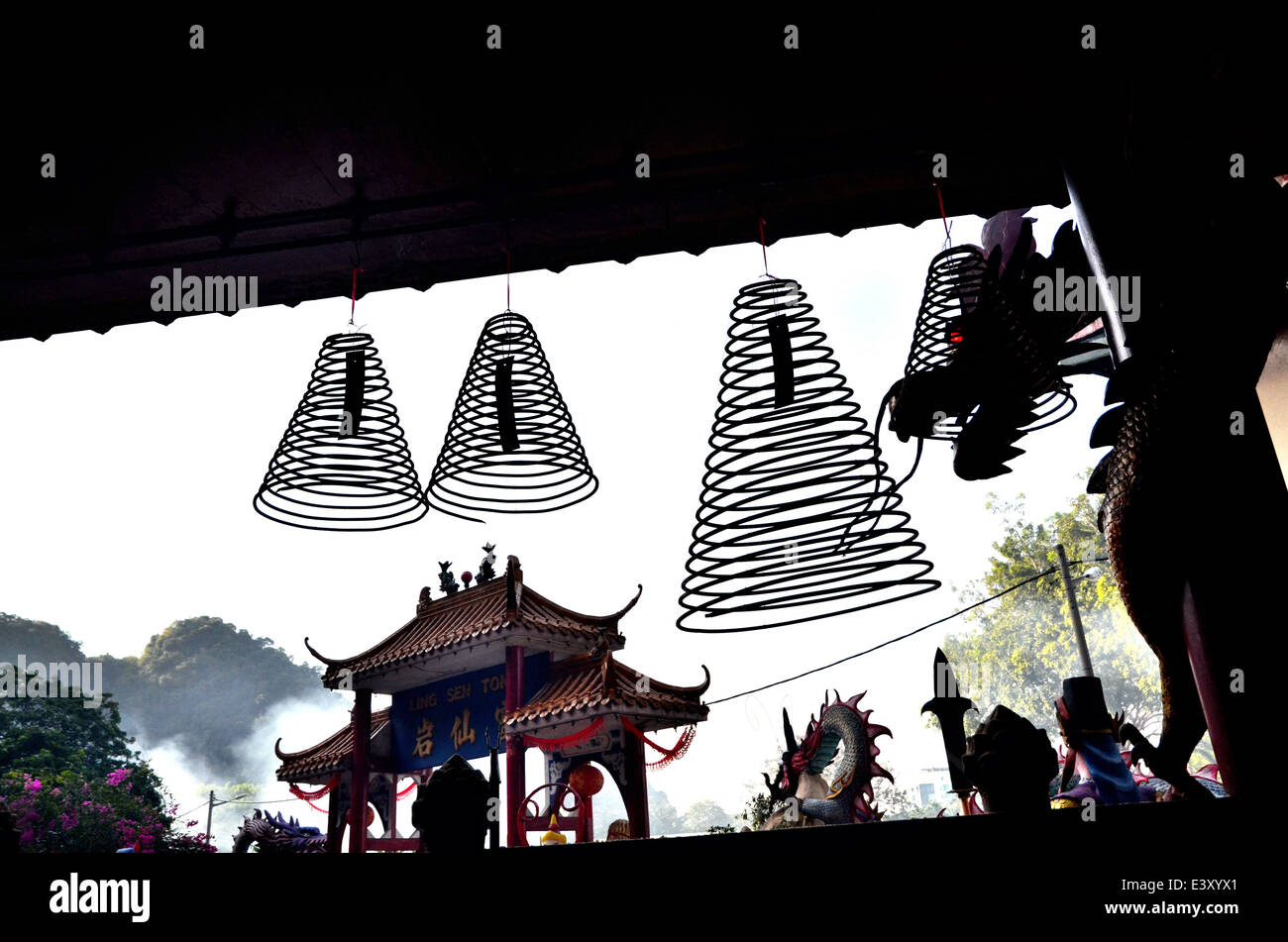 Rows of spiral joss sticks in silhouette hanging in temple Stock Photo ...