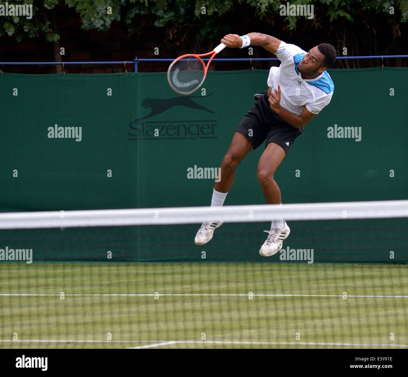 Manchester, UK. 1st July, 2014. Joshua Ward-Hibbert serves during his 4 ...