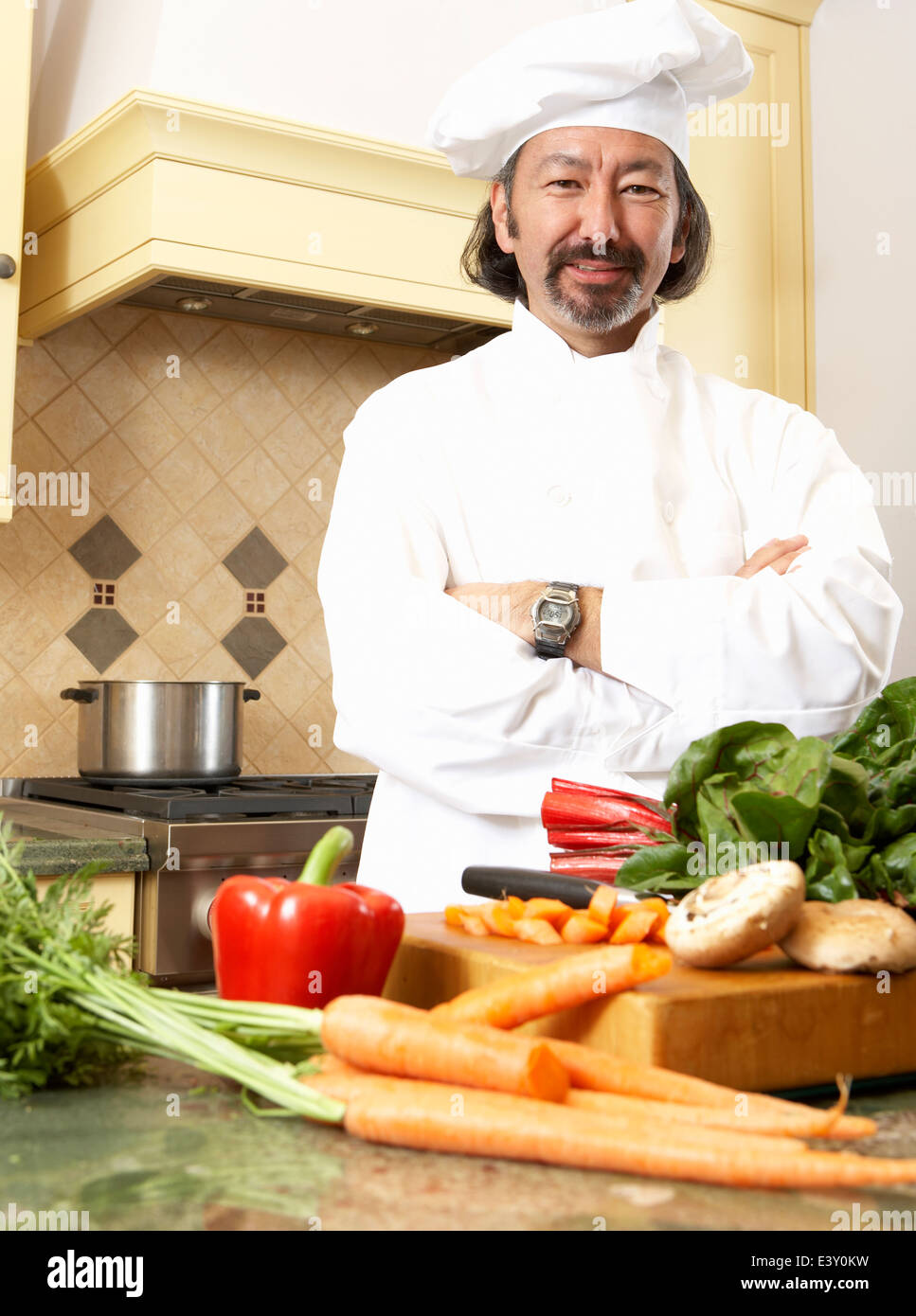 Mixed race chef working in kitchen Stock Photo - Alamy