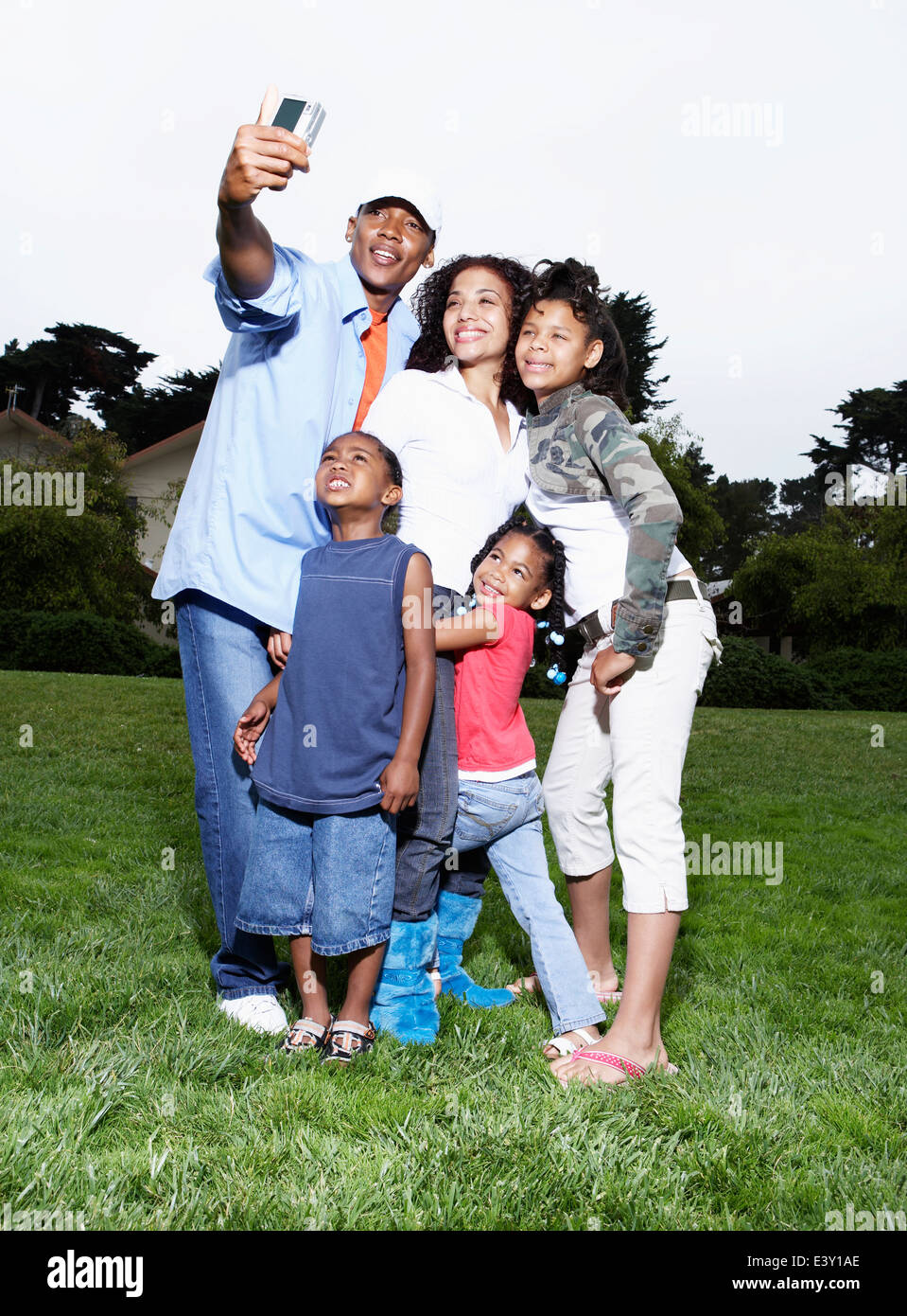 Family taking picture together in park Stock Photo - Alamy
